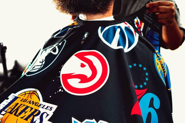 Holiday Gift Guide: The multi-logo NBA Barber cape | NBA.com